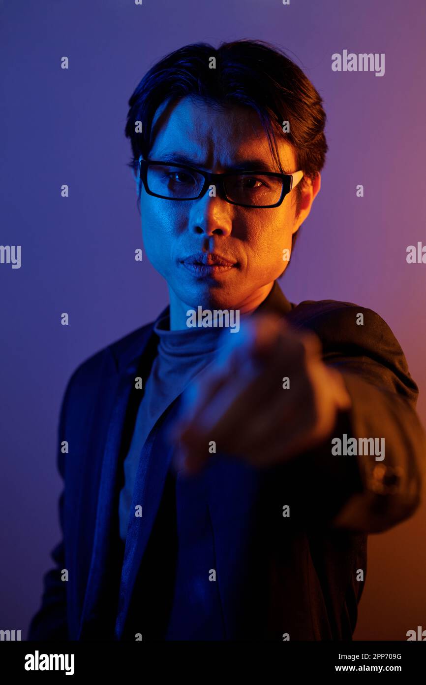 Angry confident man in glasses pointing at camera Stock Photo - Alamy