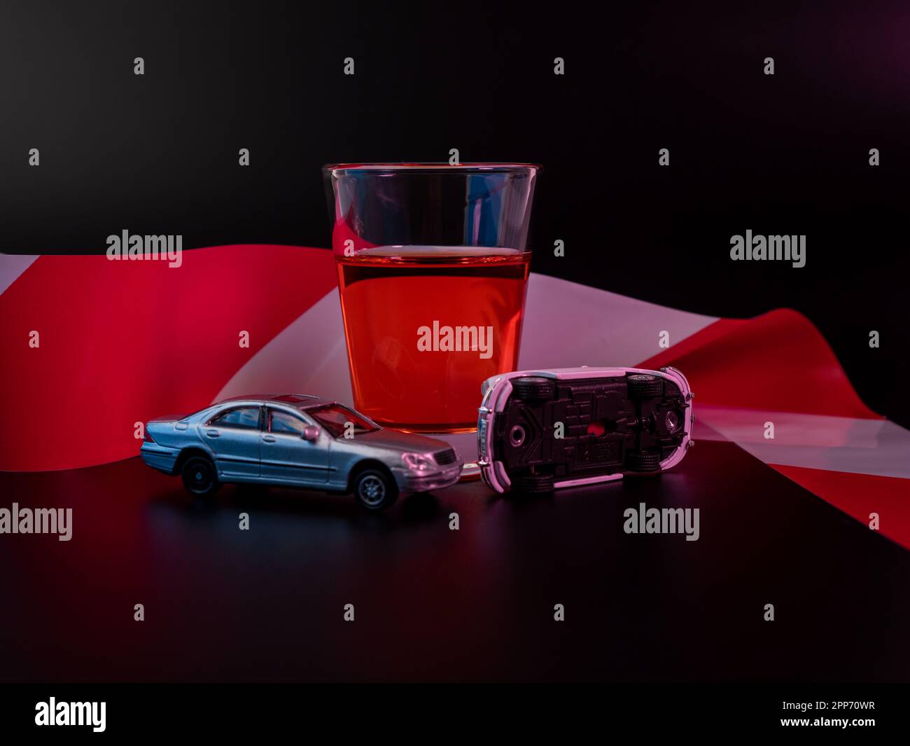 Mini car accident. Alcohol and a toy car on a black background. Drunk ...