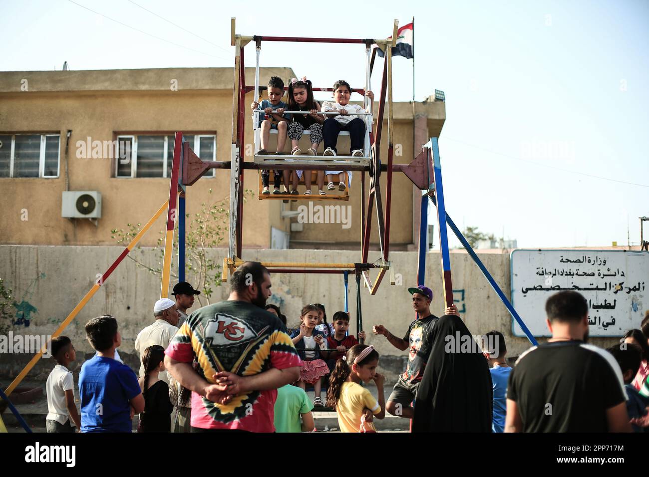 Baghdad, Iraq. 22nd Apr, 2023. Iraqi children ride on a wheel at a ...