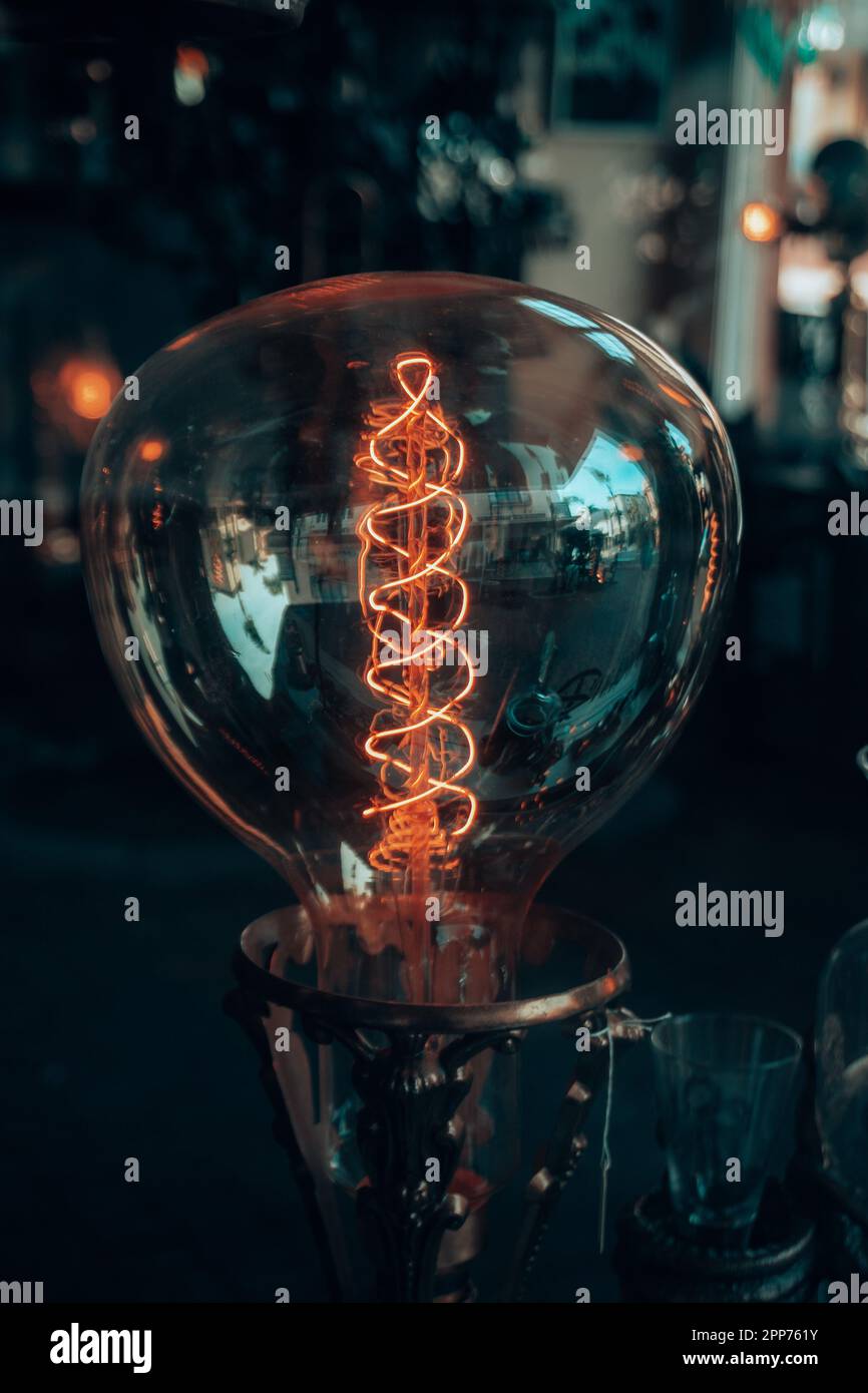 A close up image of a lightbulb illuminating the area Stock Photo - Alamy