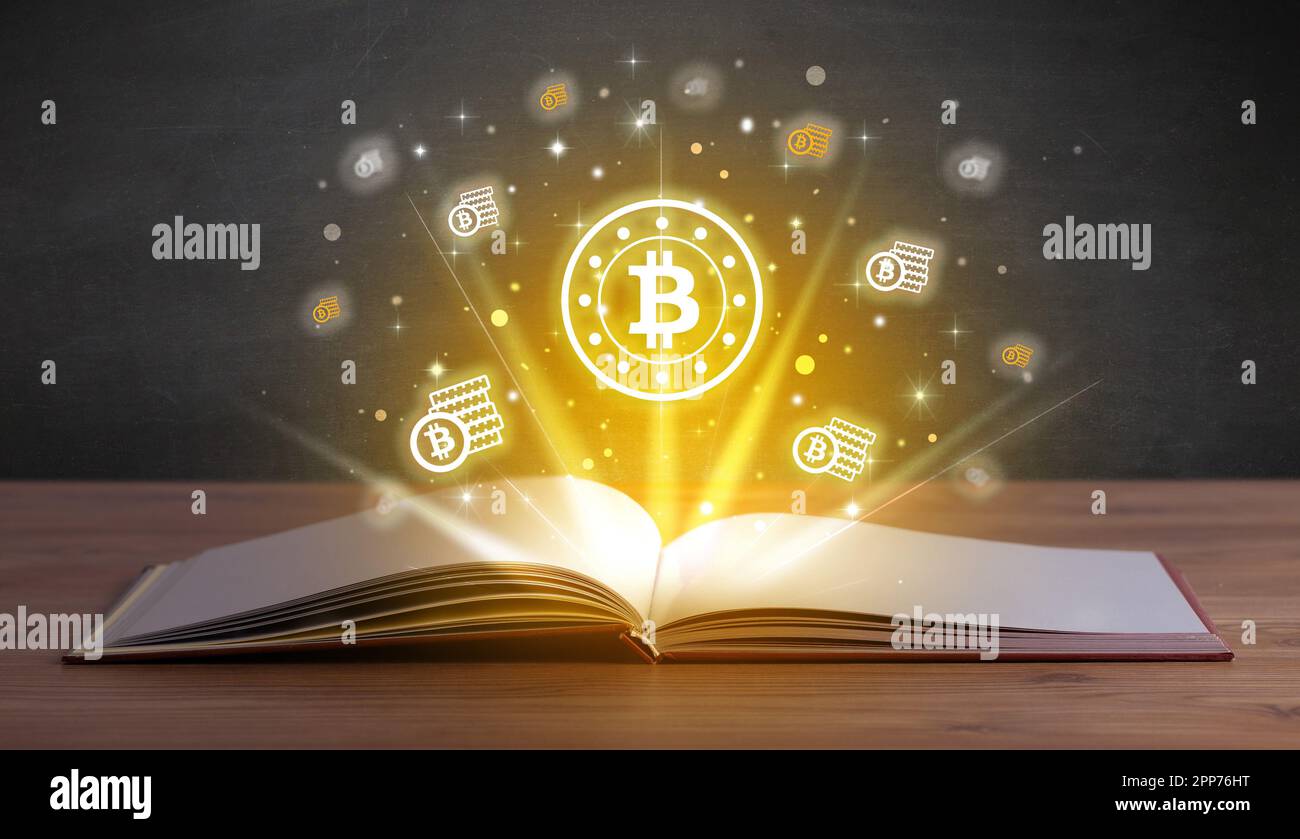 Open book with currency icons above Stock Photo - Alamy