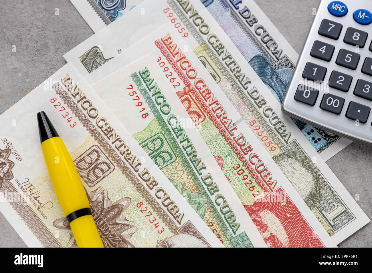 Cuban pesos, calculator and pen, financial calculation concept, home ...