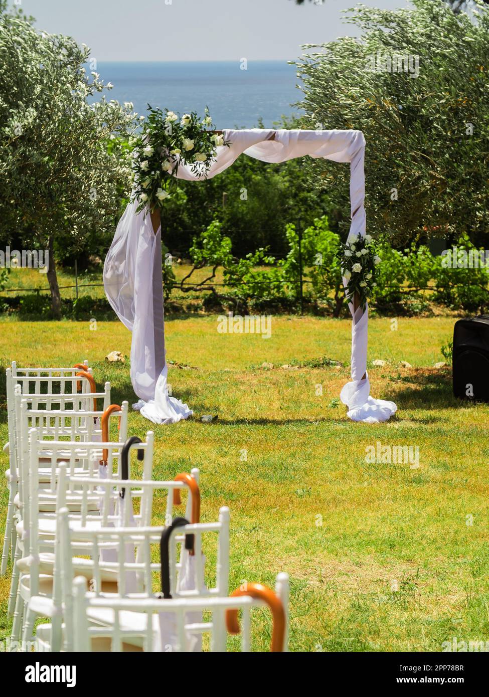 Beautiful wedding set up with wedding arch and chairs for guests ...