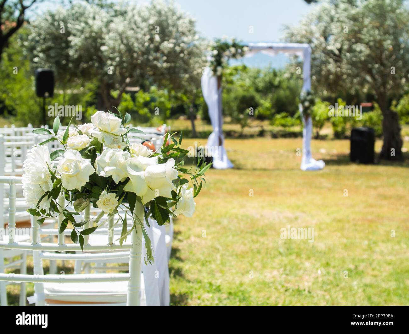 Beautiful wedding set up with wedding arch and chairs for guests ...