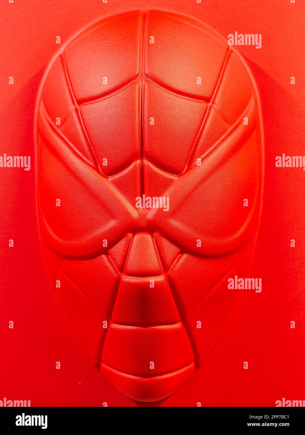 Facial Mask of Spider Man Coming out in Relief from Red Surface Stock ...