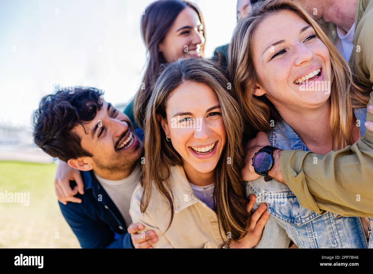 Diverse Group Of Young Adult Friends Having Fun Hugging Each Other