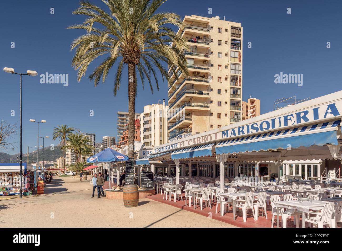 People walking by terraces of bars, restaurants in the avenue of the ...