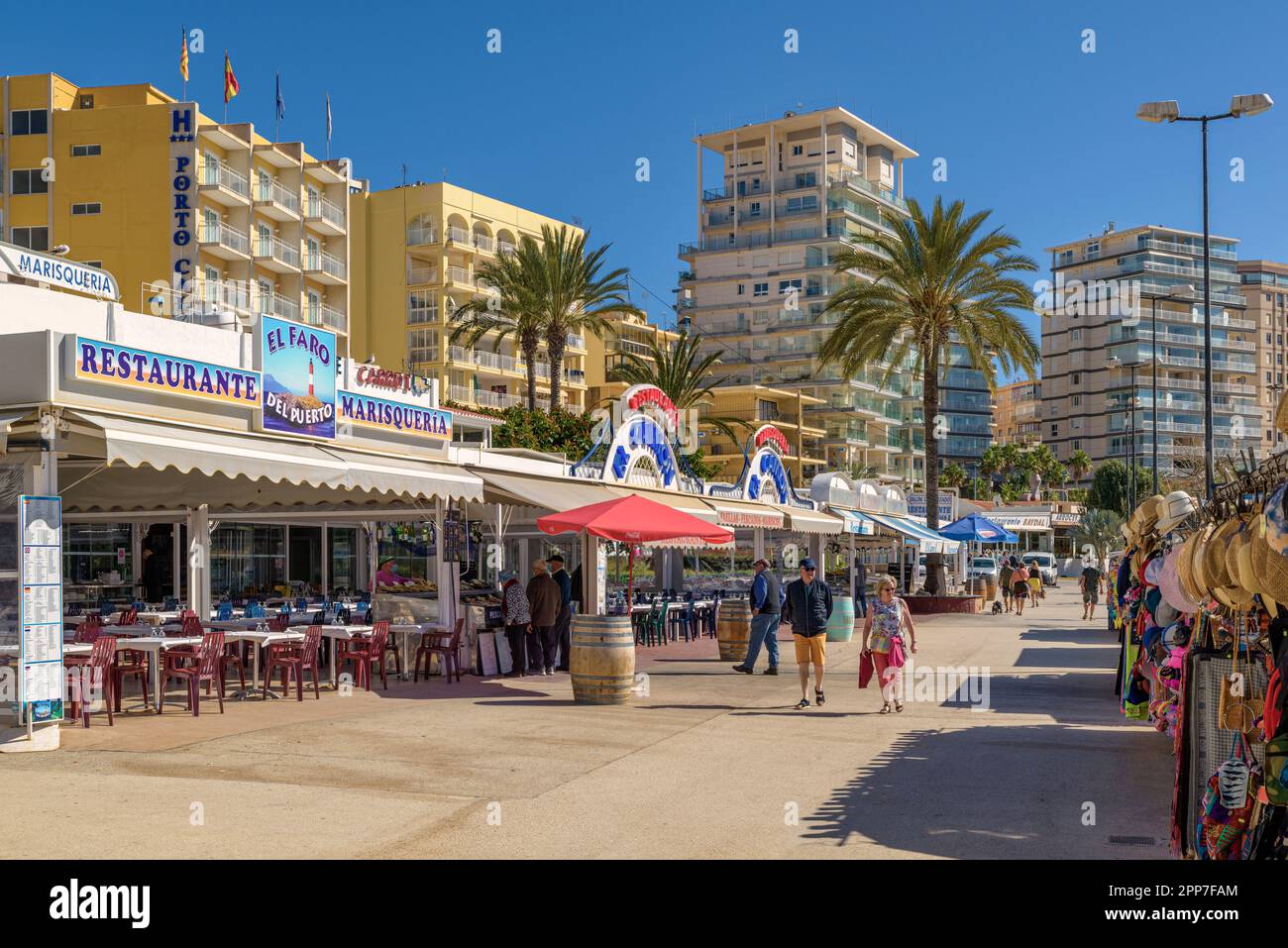 People walking by terraces of bars, restaurants in the avenue of the ...