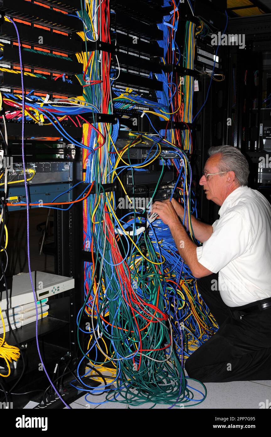 An engineer examining machine in computer room data center Stock Photo ...