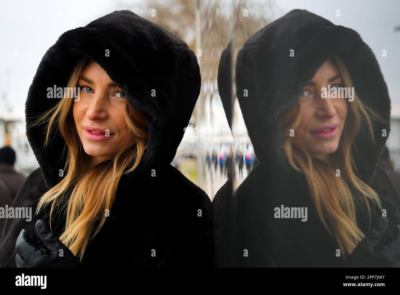 Portrait of a woman standing at a window Stock Photo - Alamy