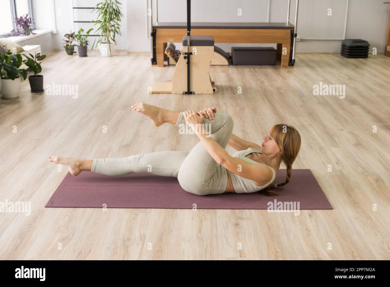 Young sporty attractive women doing pilates toning exercises for abs ...