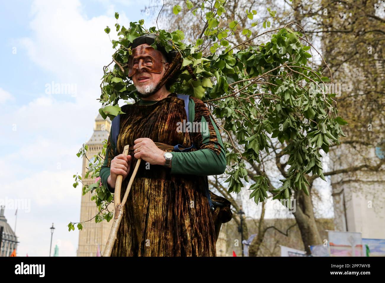 London, UK. 22nd Apr, 2023. A protesters on a stilts dressed as a tree ...