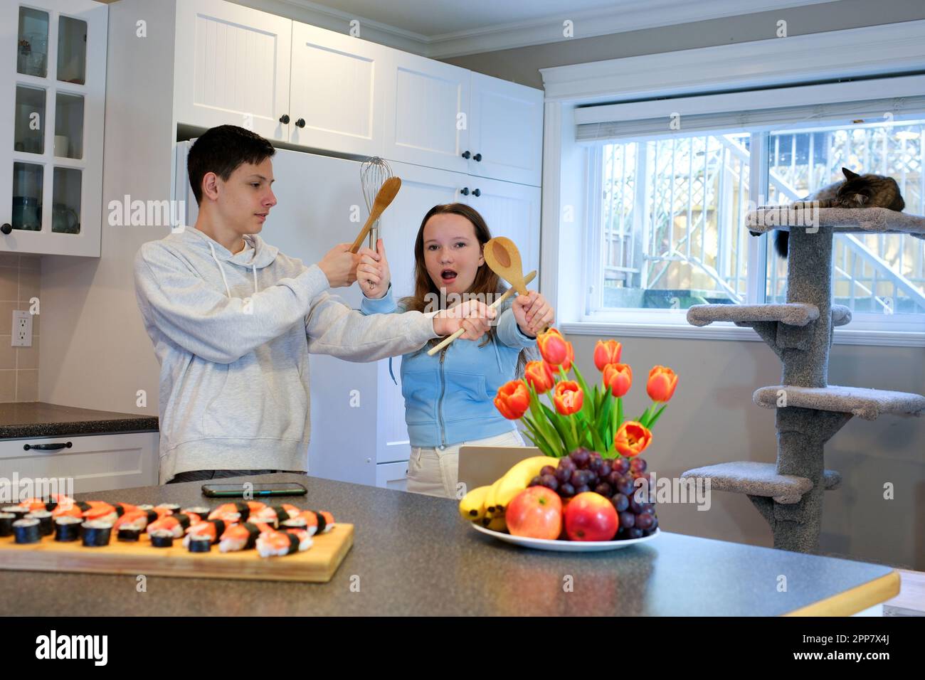 Funny happy family young teen enjoying dancing, singing, jumping in ...