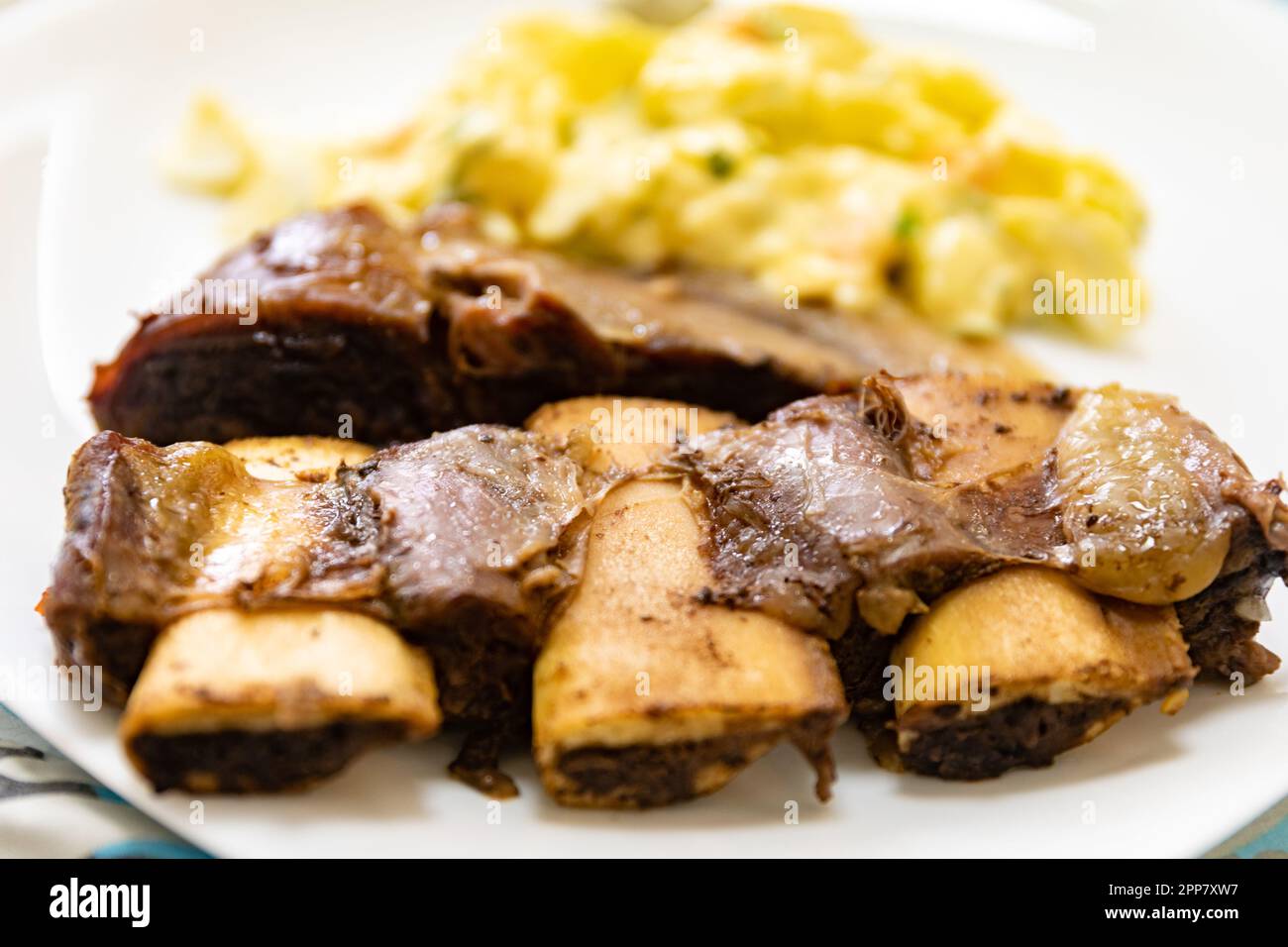 Traditional barbecued ribs with mayonnaise salad. Gaucho culture Stock ...