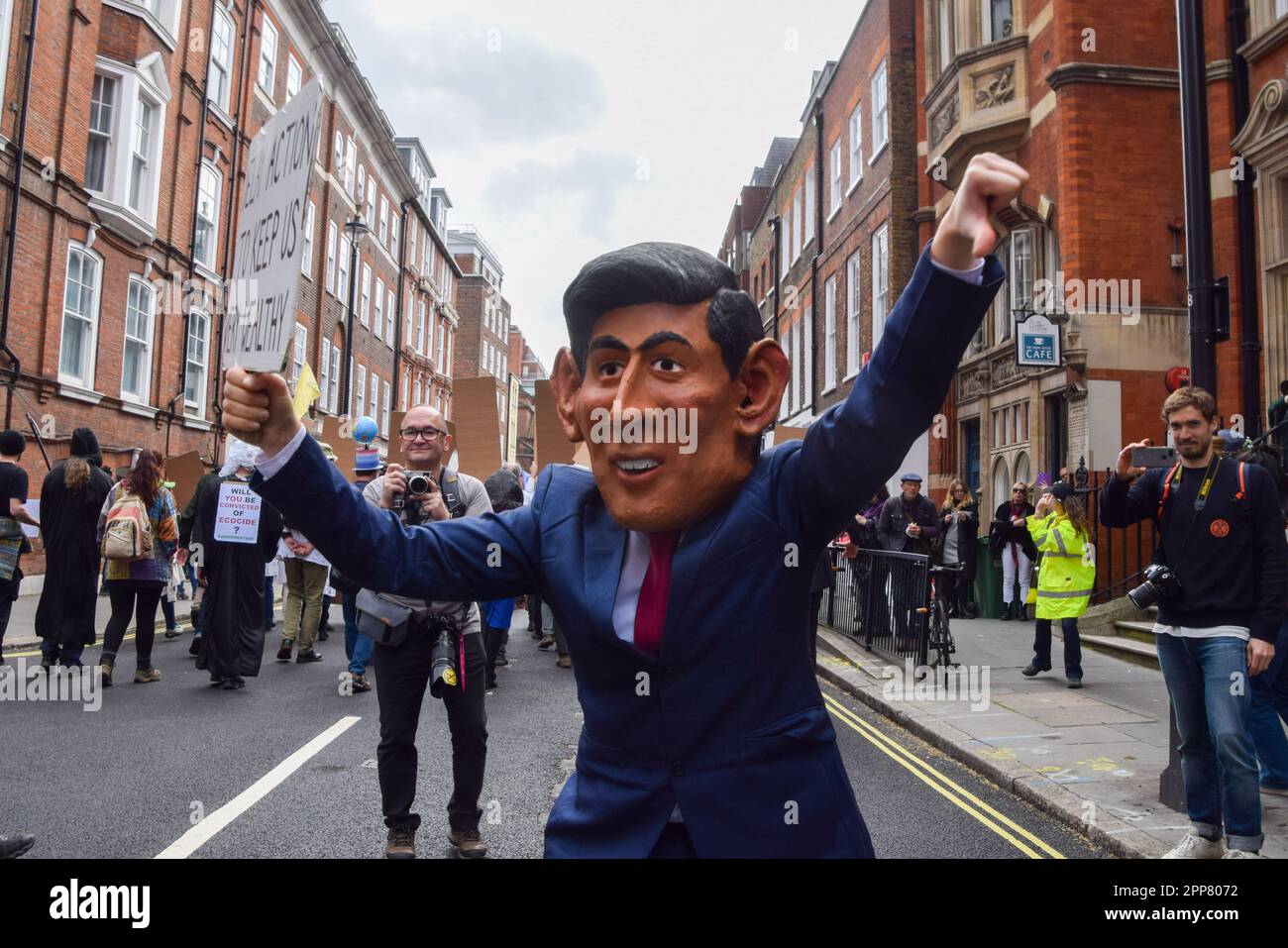 London, UK. 22nd April 2023. A protester wears a Rishi Sunak mask ...