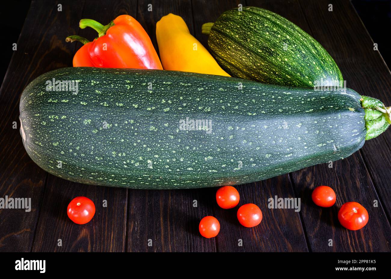 Vegetable marrow zucchini, sweet pepper and tomatoes on dark background ...