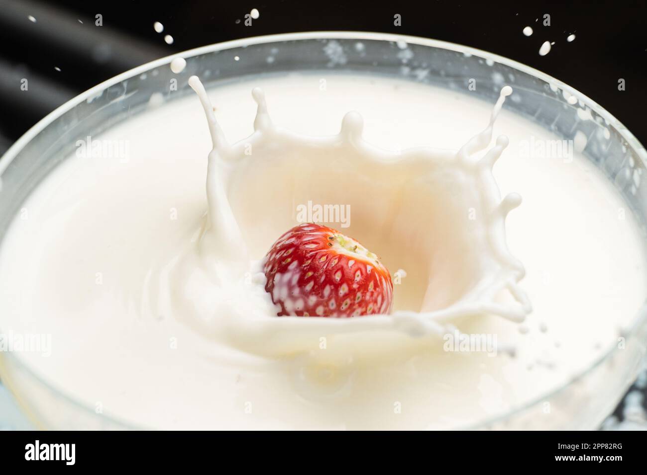 Strawberry falling into splashing milk. Isolated on white Stock Photo ...