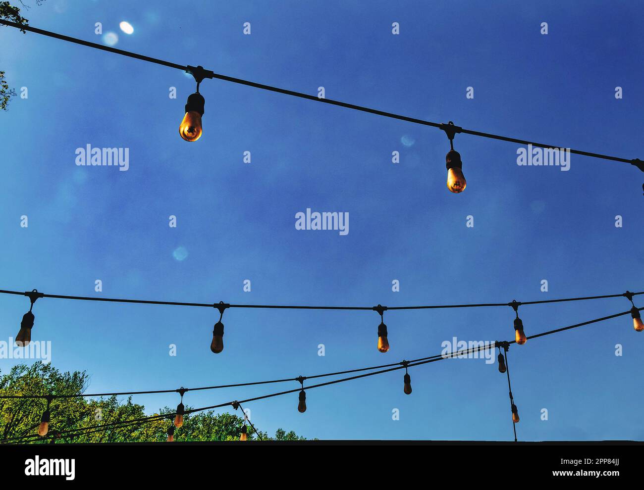 String of outdoor lights over a patio Stock Photo - Alamy
