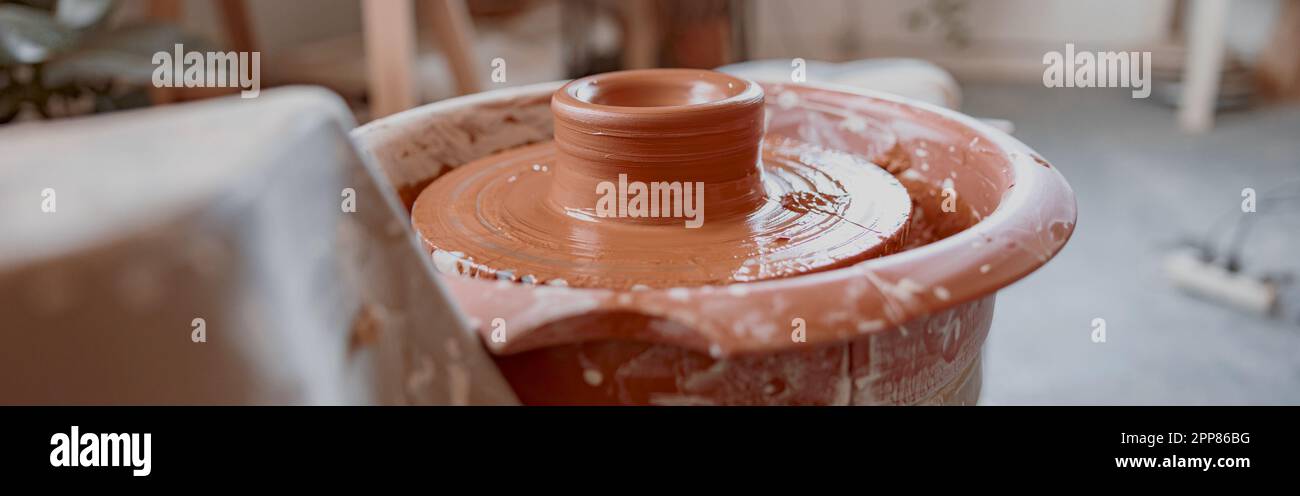 Raw clay product on potter wheel in workshop Stock Photo - Alamy