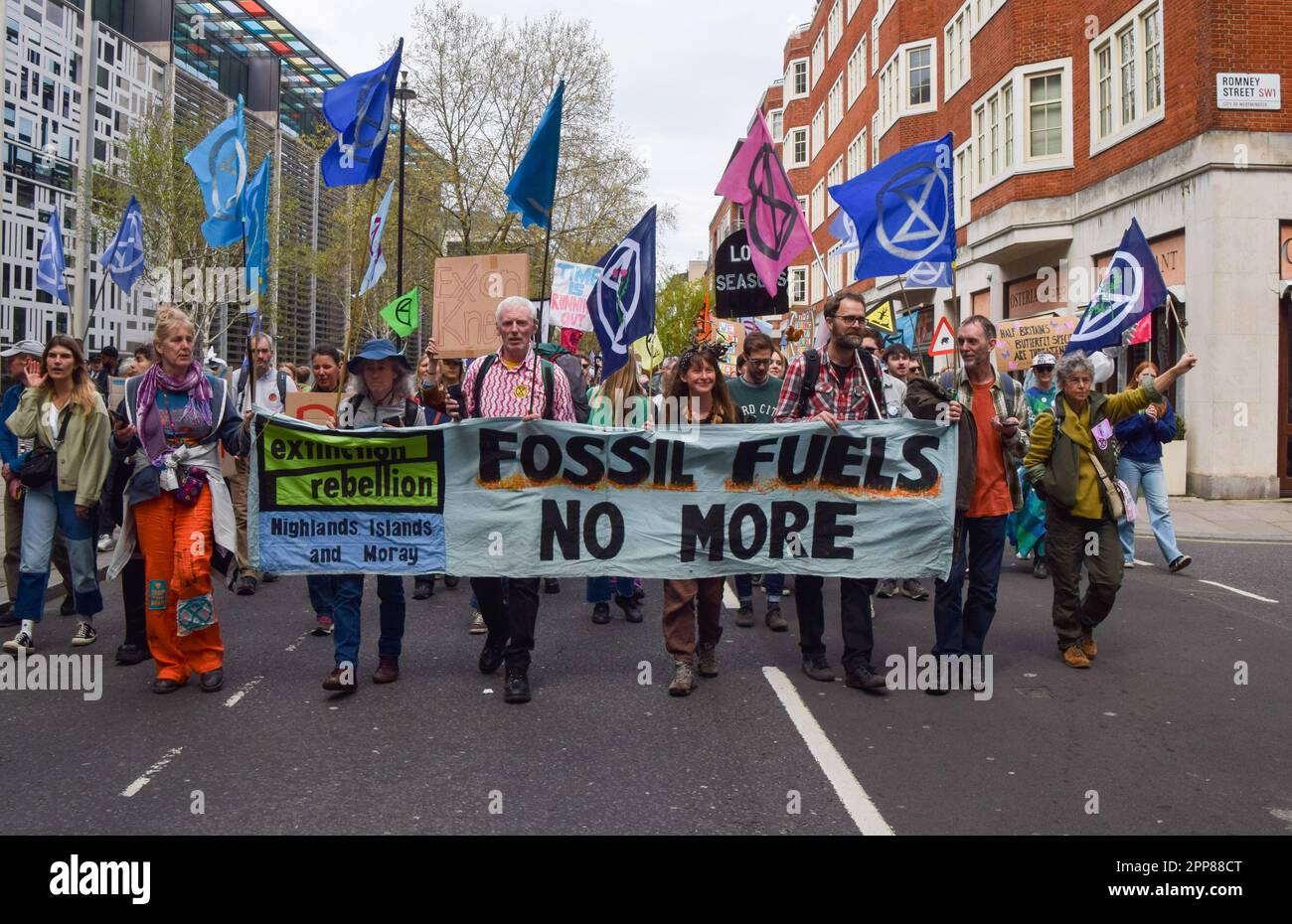 London, UK. 22nd Apr, 2023. Protesters hold an anti-fossil fuels banner ...