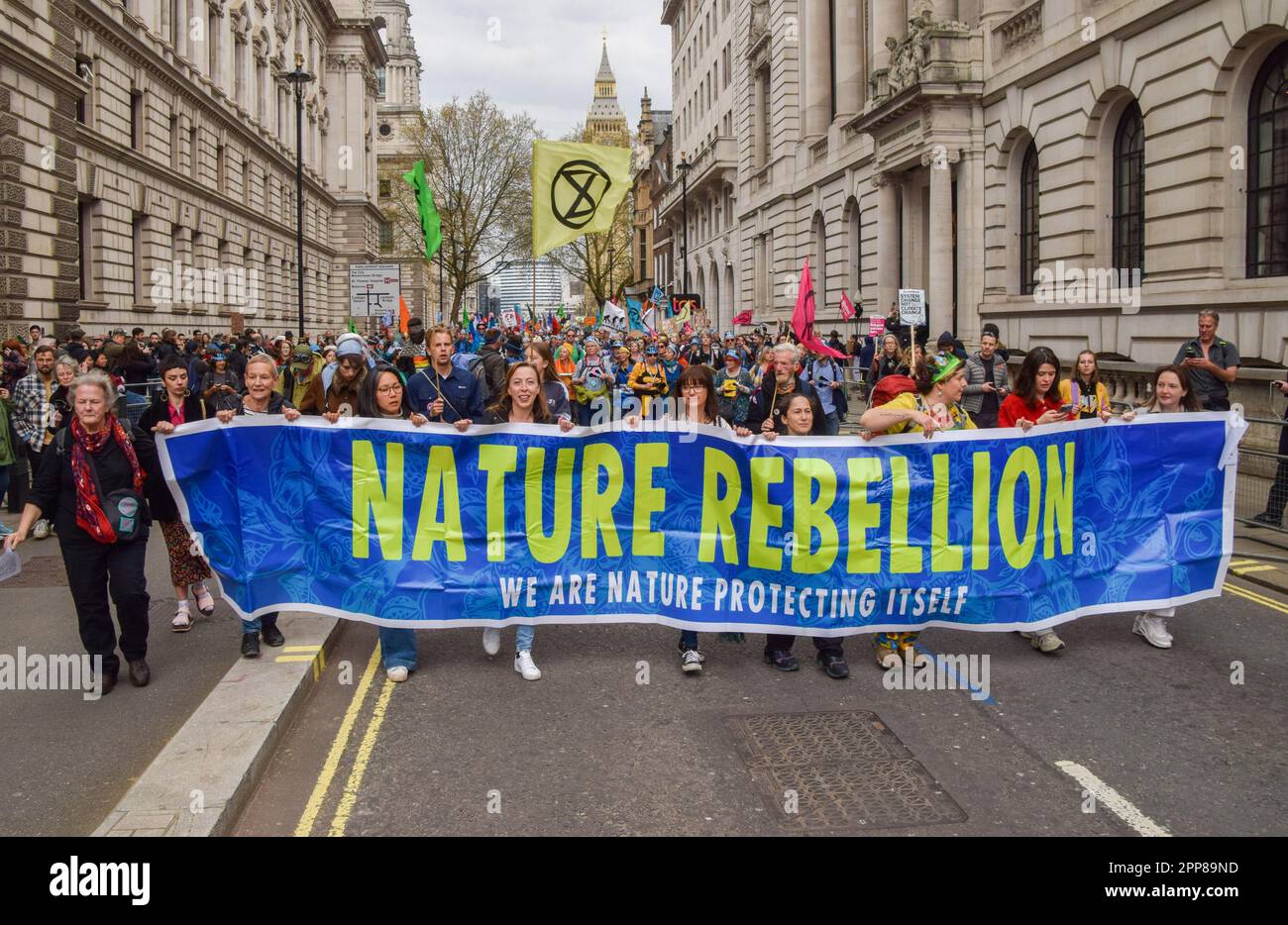 London, UK. 22nd Apr, 2023. Protesters march with a 'Nature rebellion ...