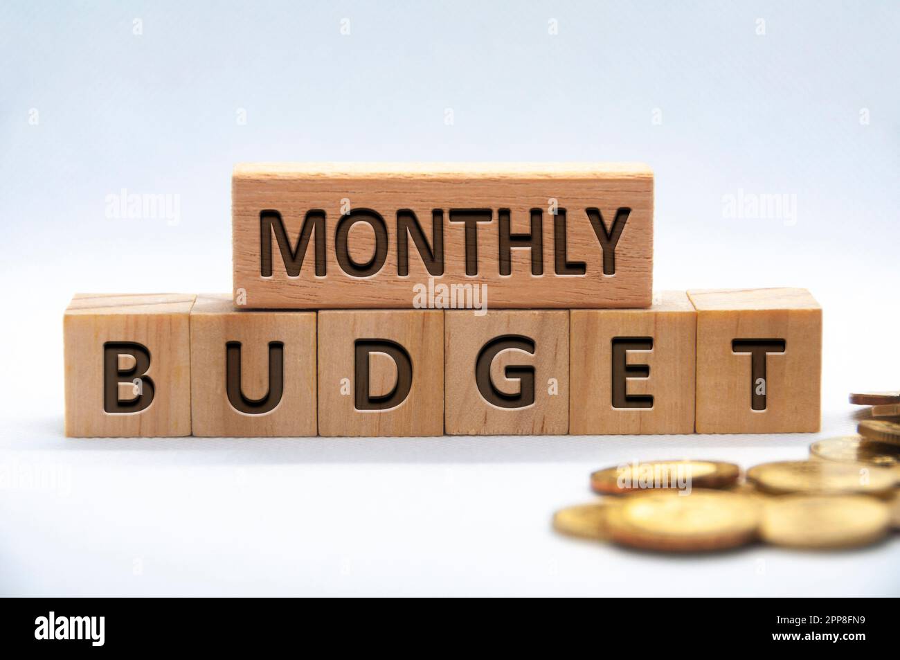 Monthly budget text engraved on wooden blocks on white background cover ...