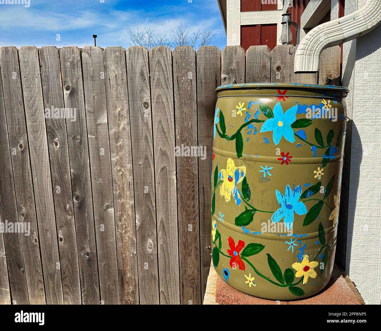 Painted Flowers on Green Rain Barrel by Wood Fence - Sustainable living ...
