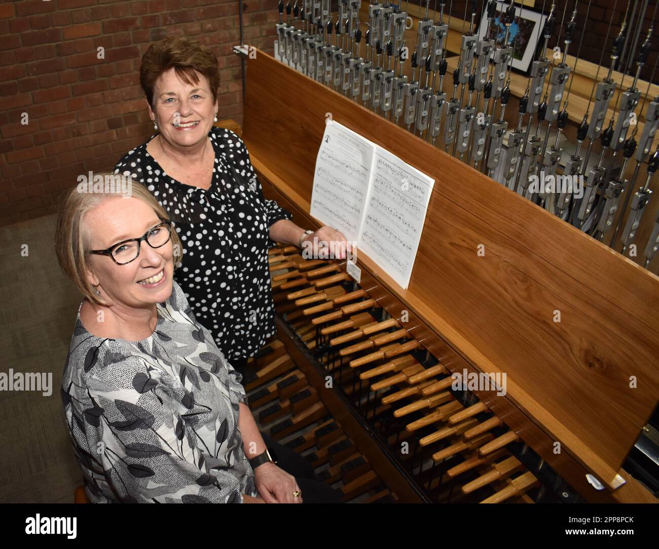 Carillon player Denise Garland (back) and fellow carillonist Wendy ...