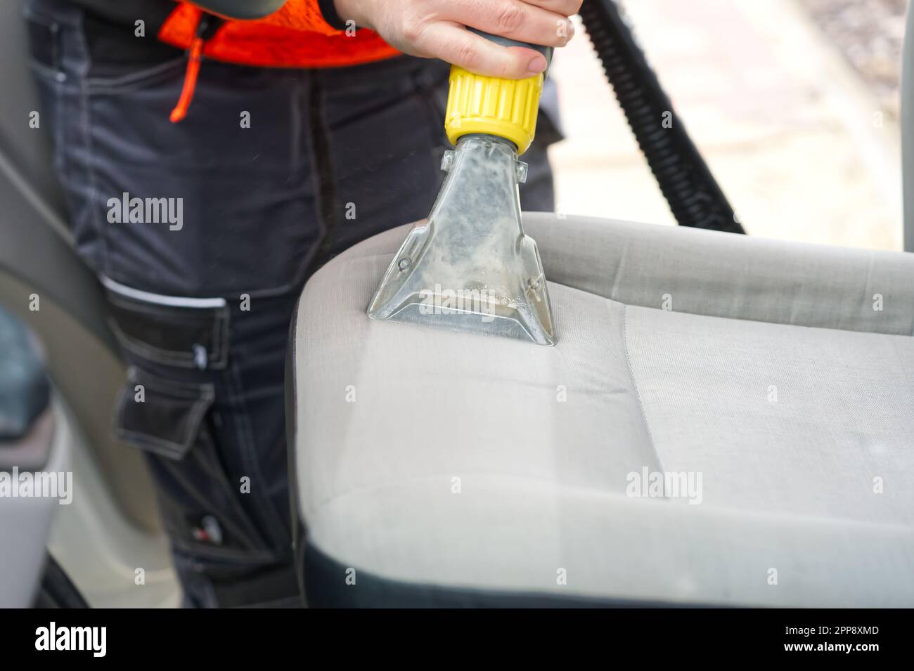 Handyman vacuuming car front textile hi-res stock photography and ...