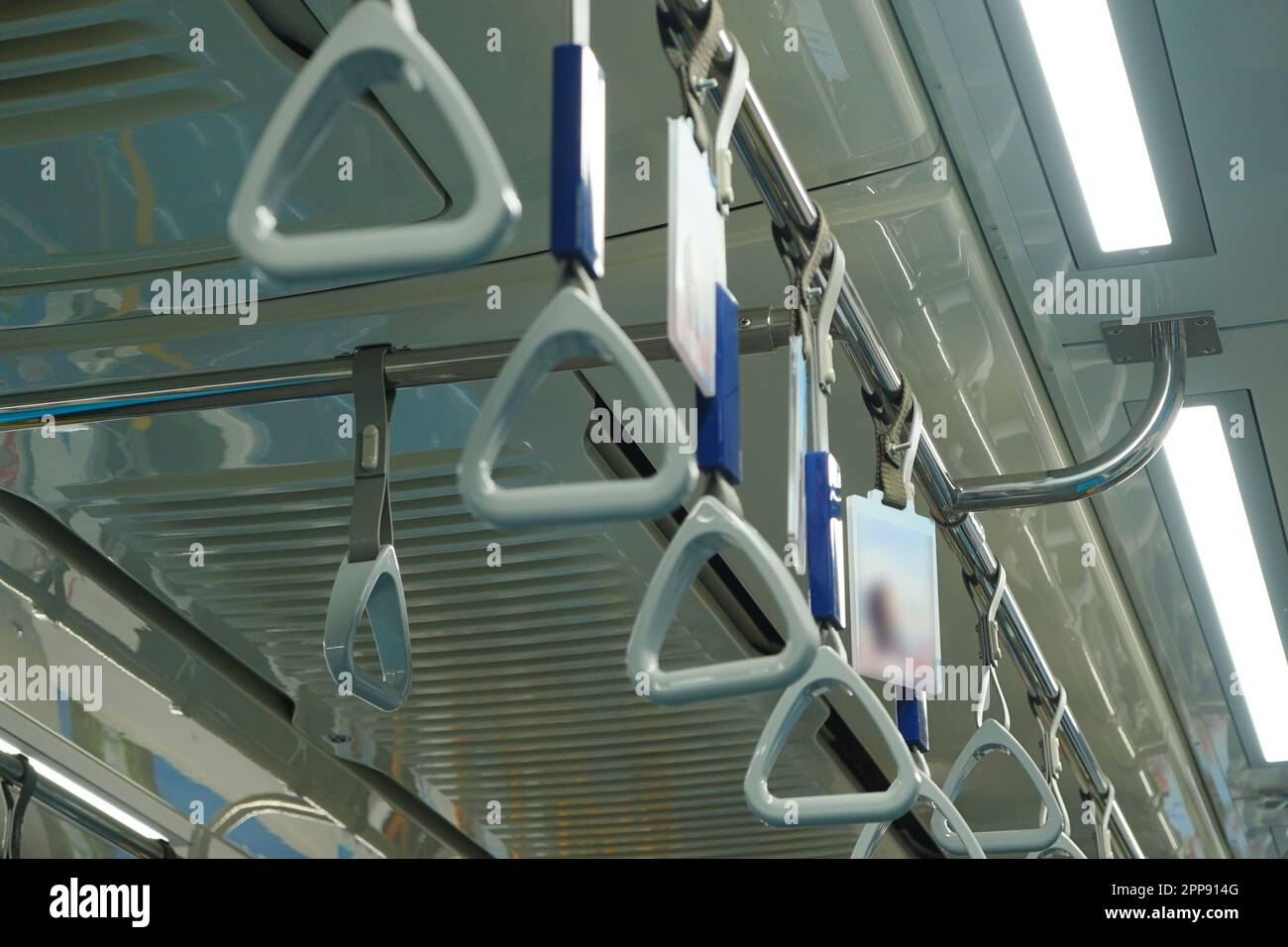 Close up and selective focus of grey triangle handle bar in the train ...