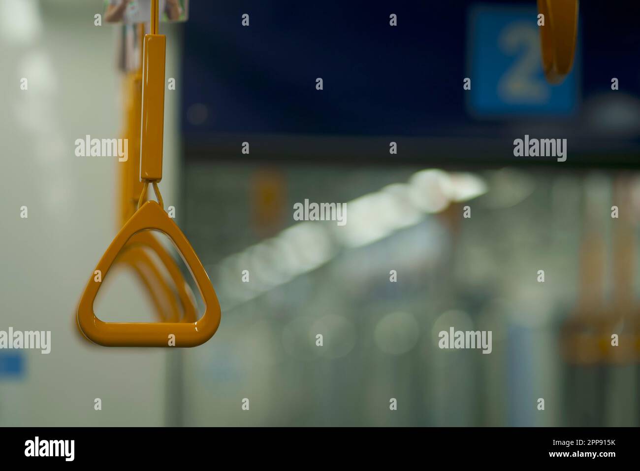 Close up and selective focus of yellow triangle handle bar in the train ...