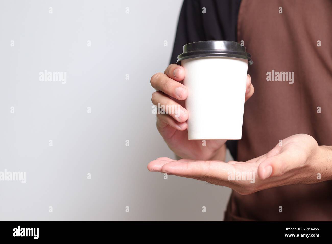 Mockup of barista male hand holding a coffee paper cup. Isolated image ...