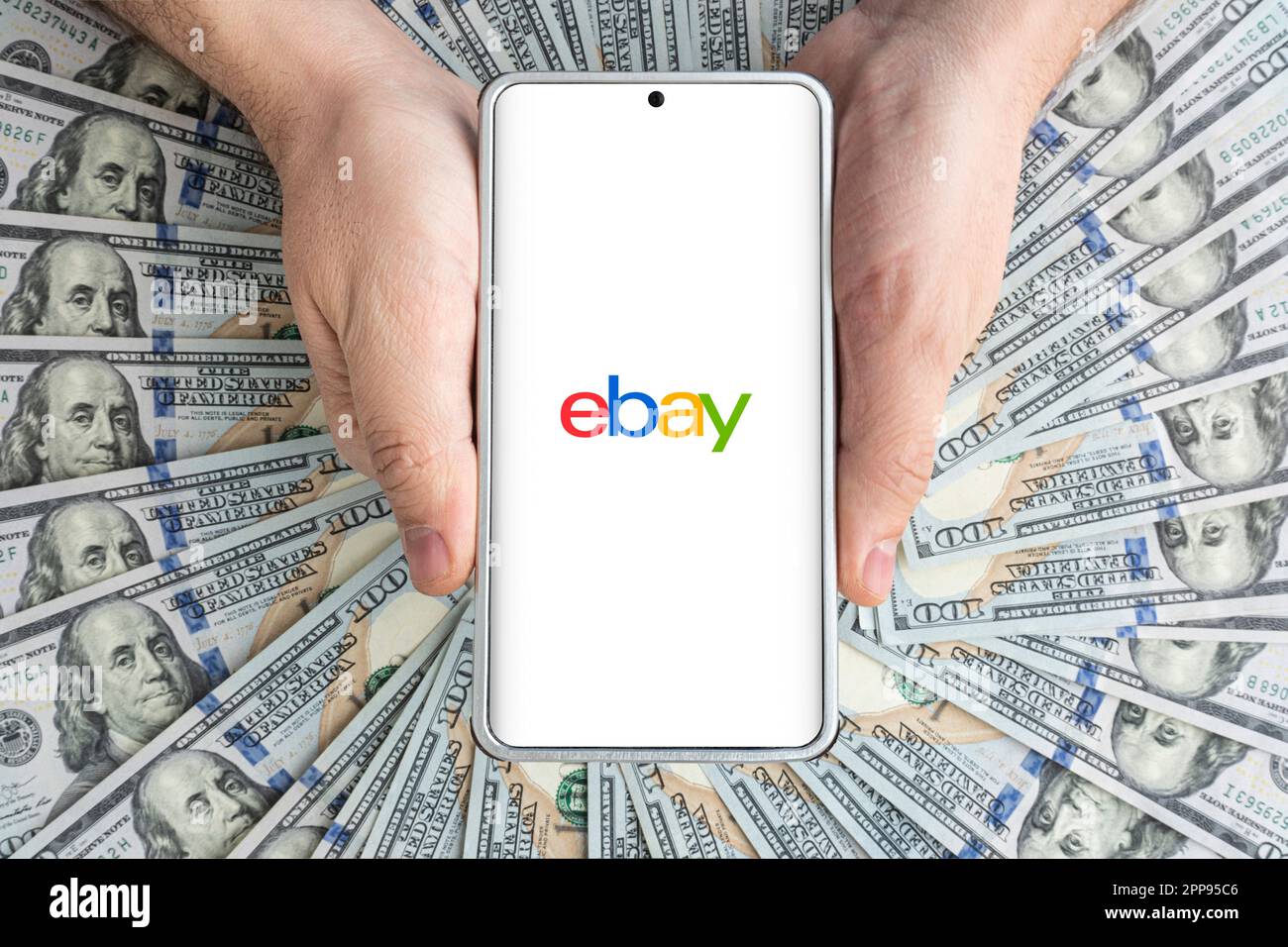 the logo of the ebay website on the smartphone screen in men's hands ...
