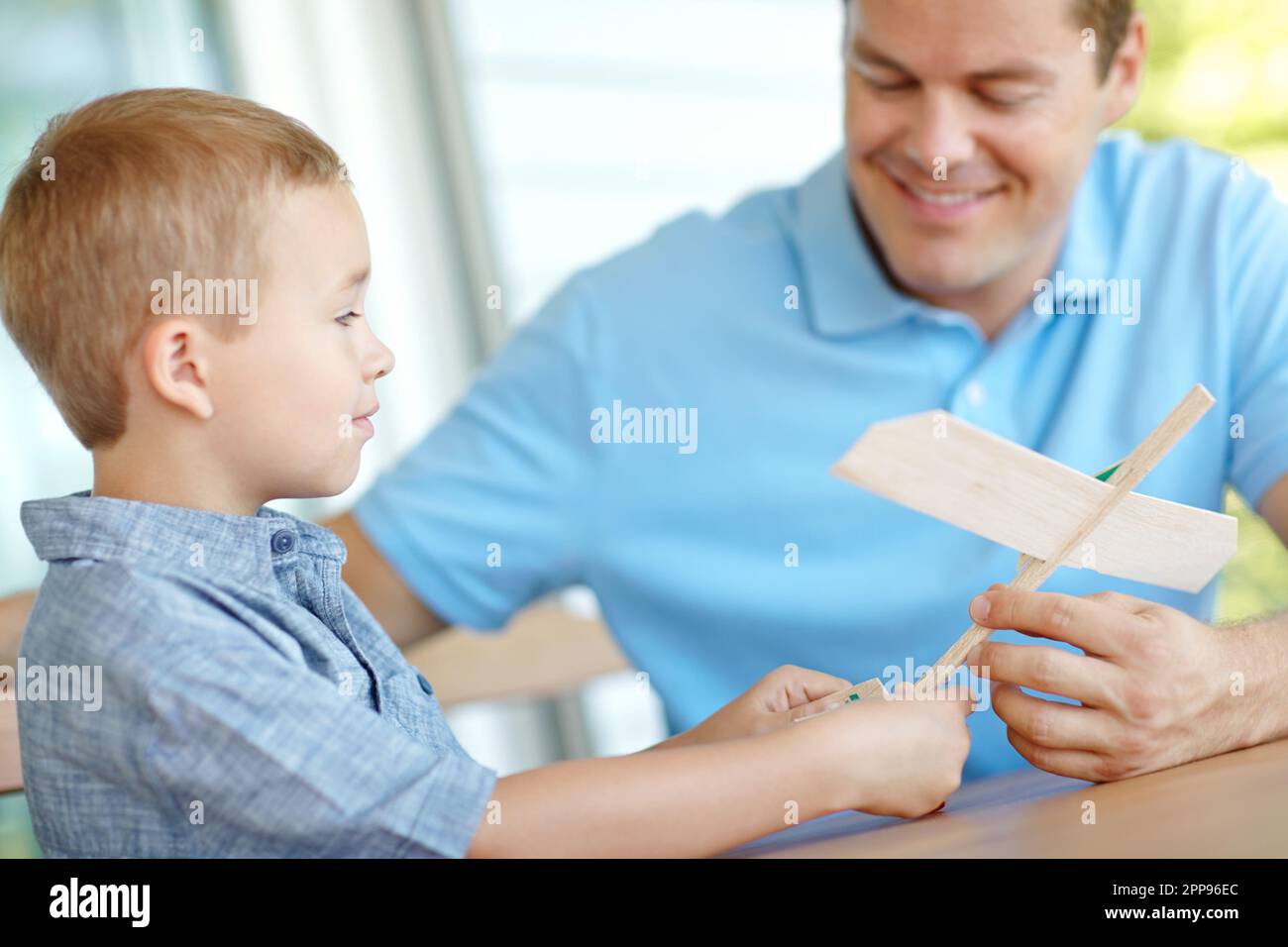 Building a model airplane together. a father and son playing with a ...