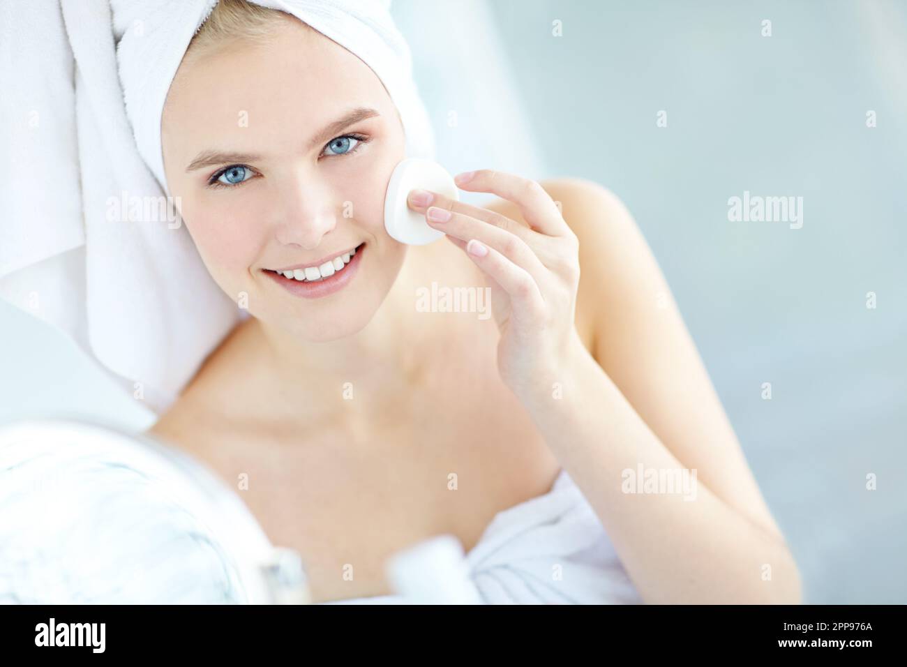 Using the best skin products. Portrait of a beautiful woman cleaning ...