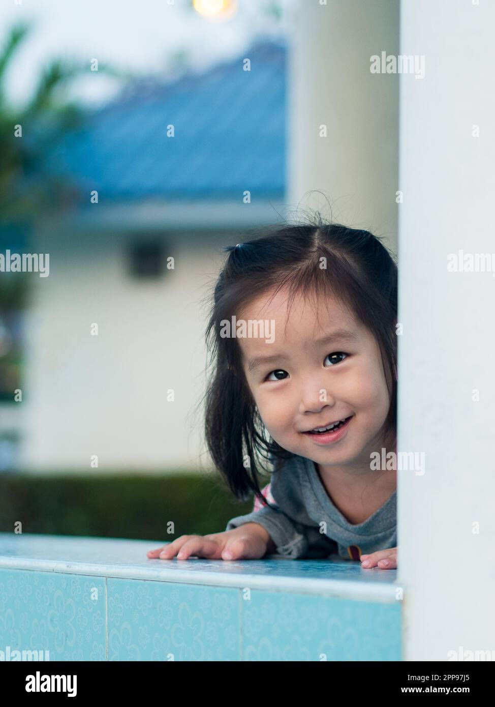 Adorable little girl playing peekaboo, asian child Stock Photo - Alamy
