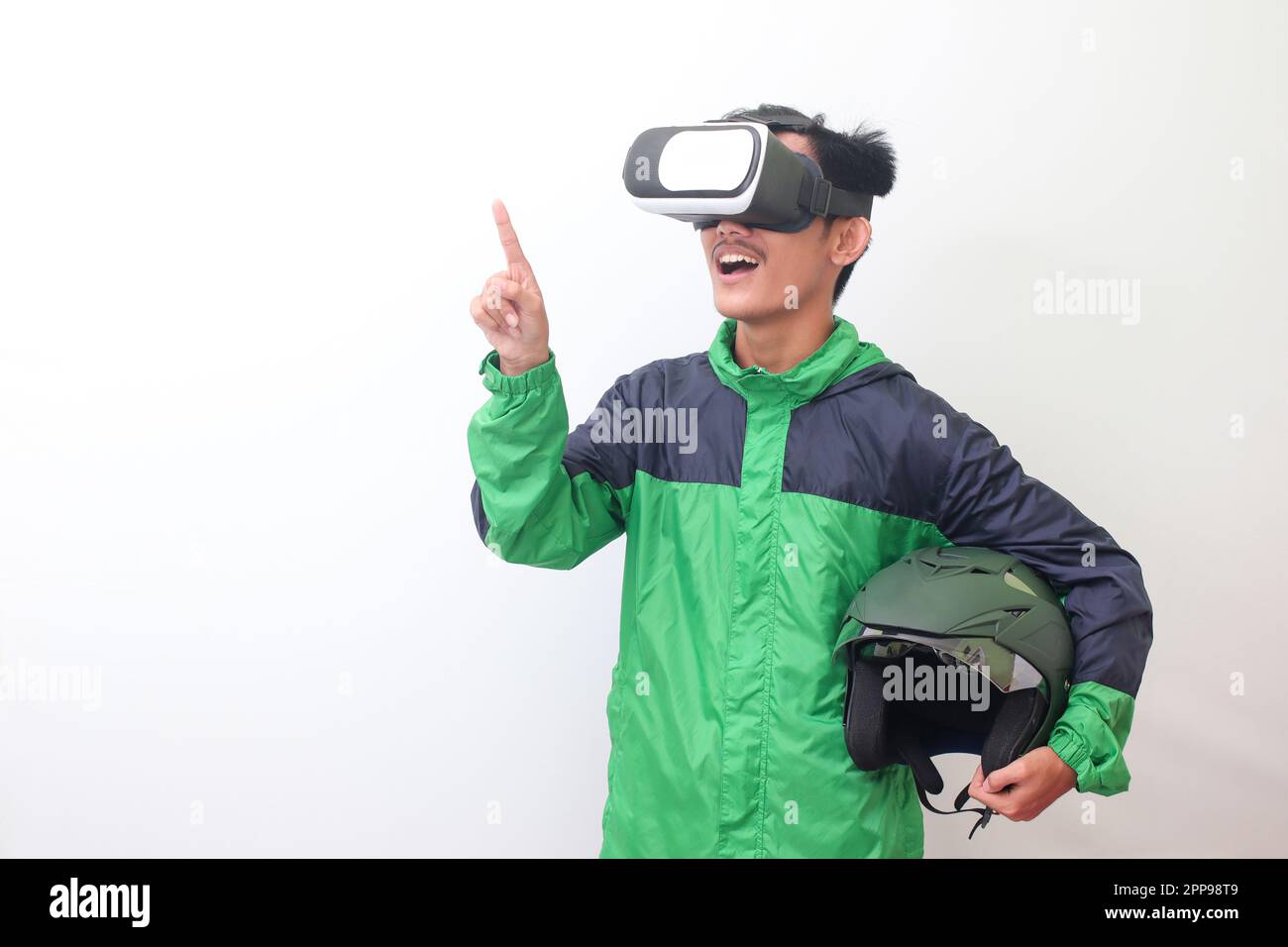 Portrait of Asian online taxi driver wearing green jacket and holding a ...