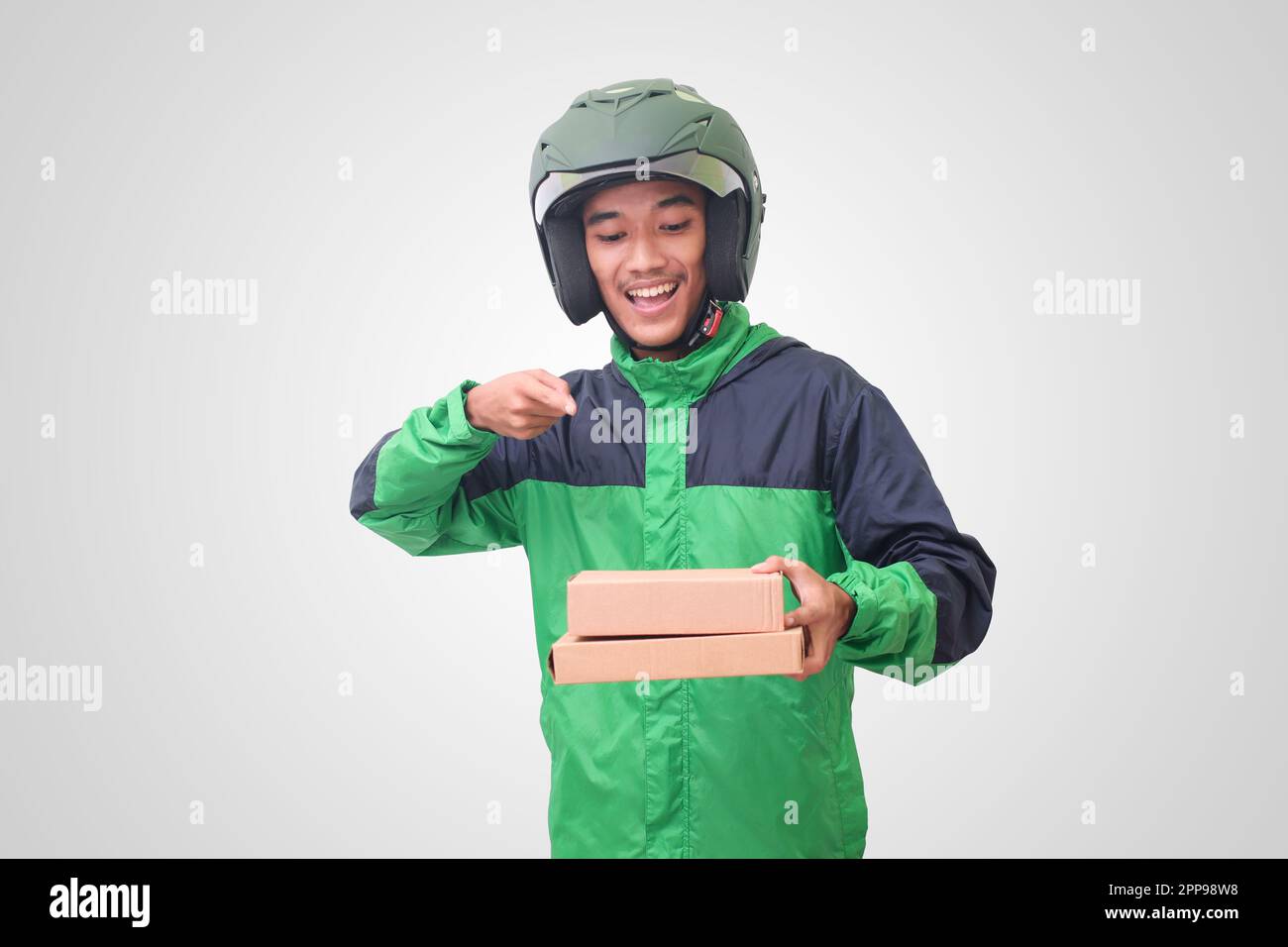 Portrait of Asian online courier driver wearing green jacket and helmet ...