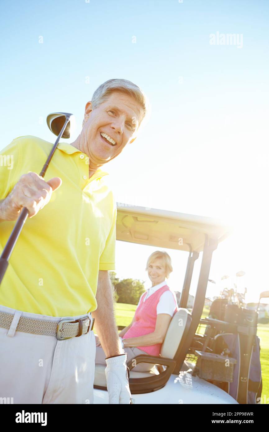 Now this is retirement. Low angle shot of a handsome older golfer ...