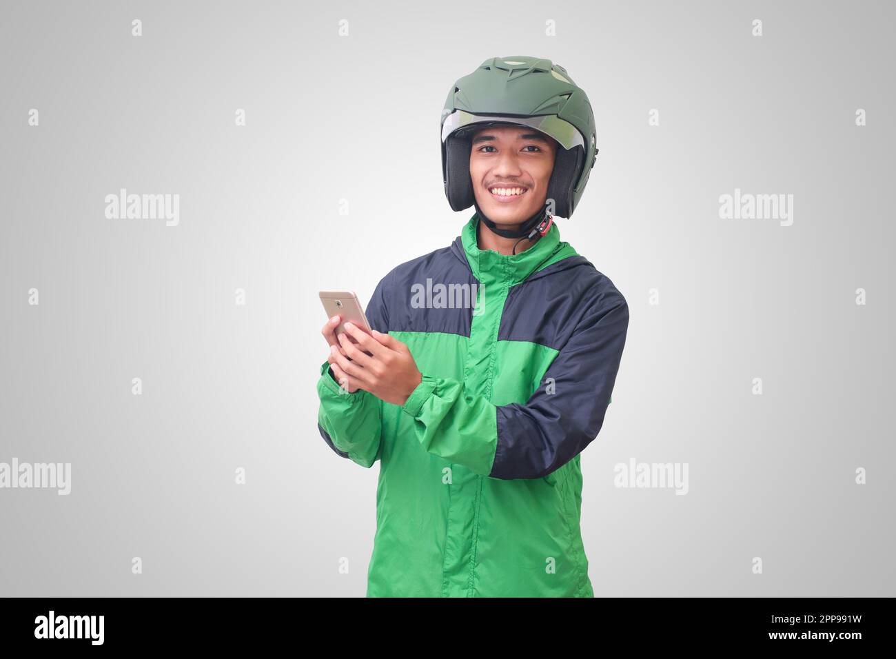 Portrait of Asian online taxi driver wearing green jacket and helmet ...