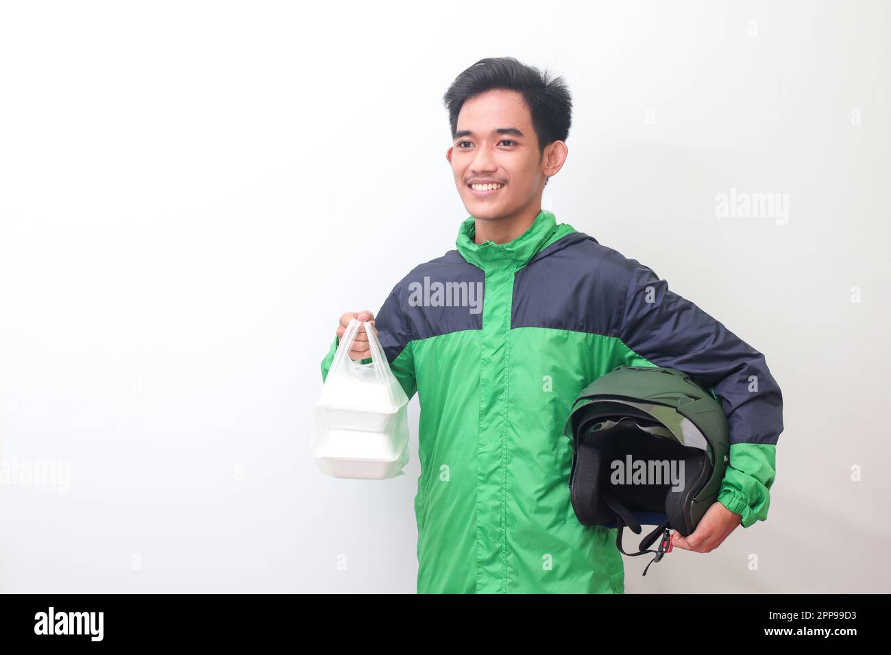 Portrait of Asian online taxi driver wearing green jacket and helmet ...