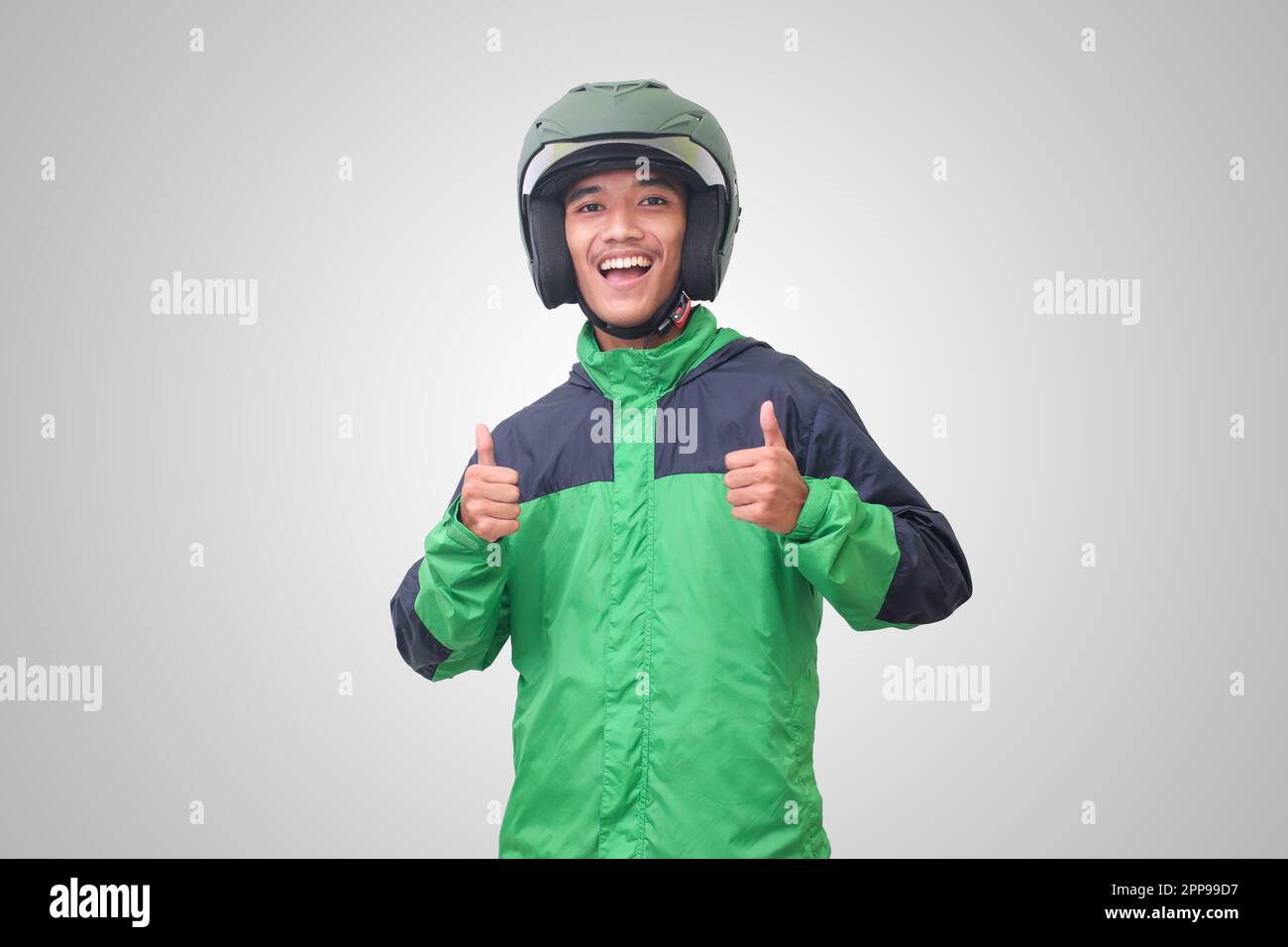 Portrait of Asian online taxi driver wearing green jacket and helmet ...