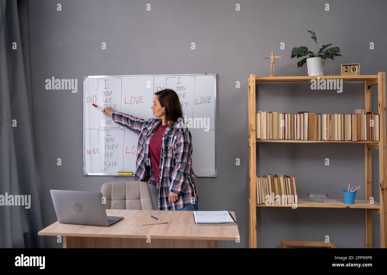 Remote Education concept. Positive woman standing near whiteboard with ...
