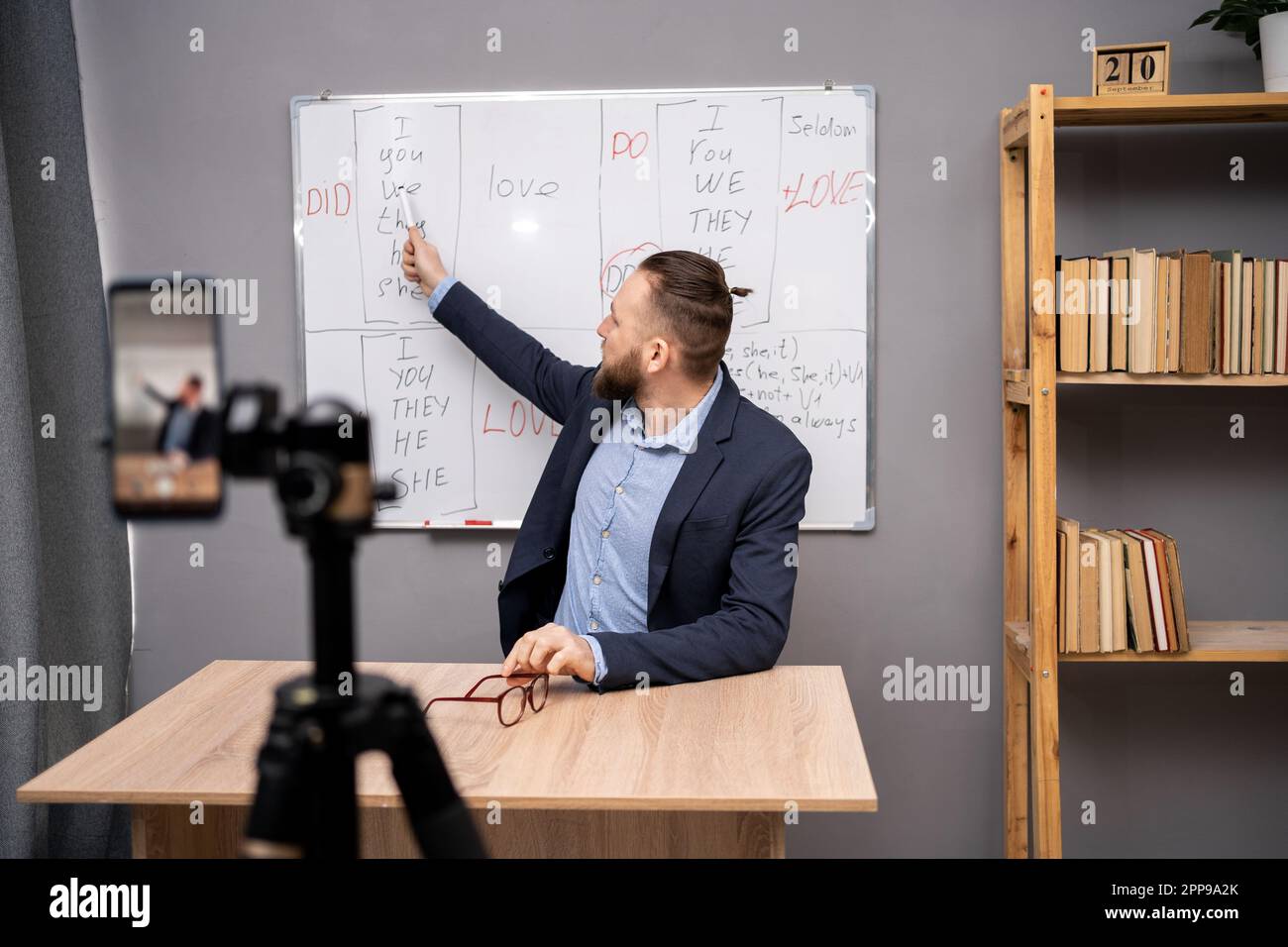 English teacher giving online lesson using whiteboard with grammar ...