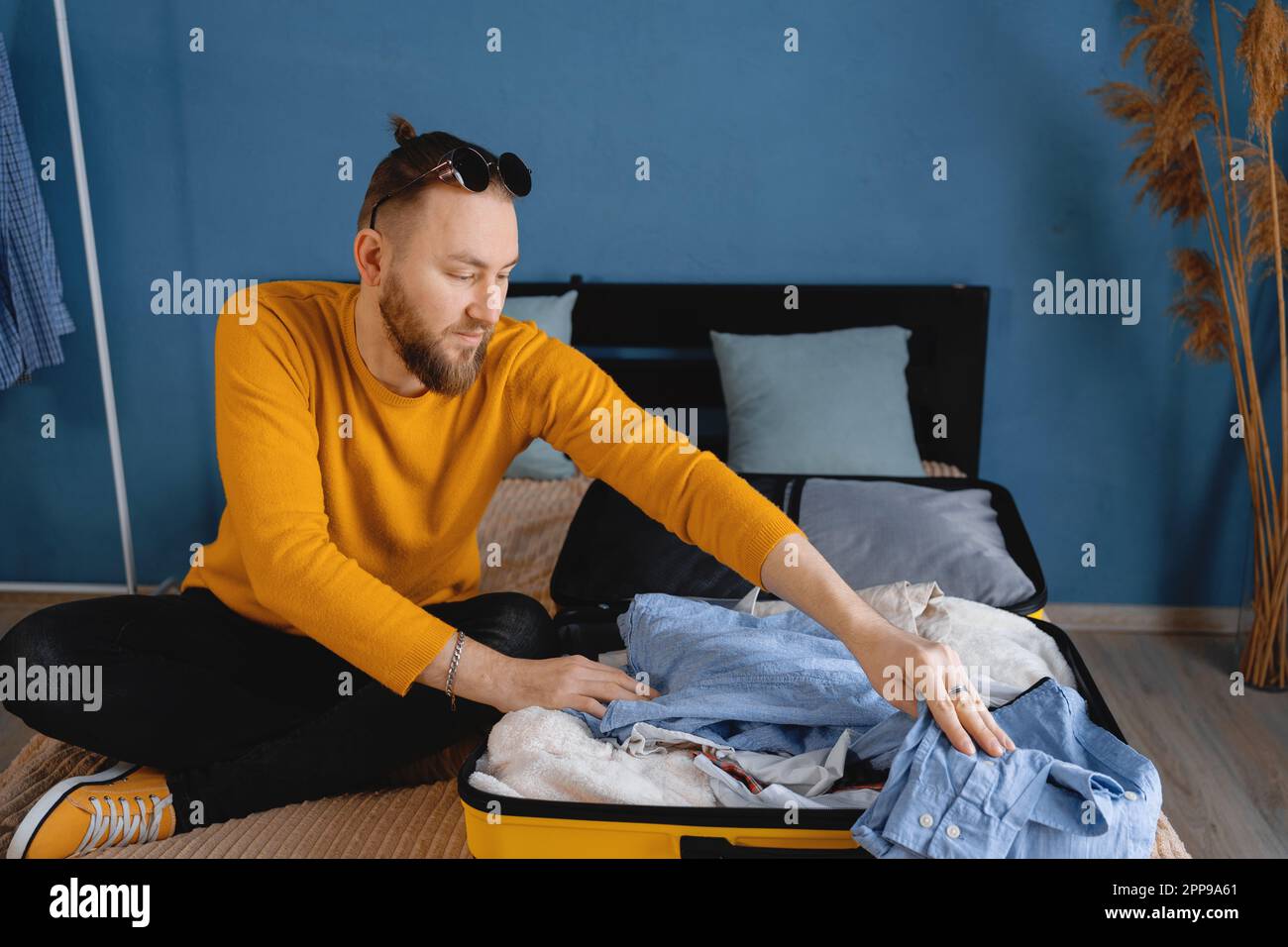 Handsome man packing luggage for a new journey and travel for a long ...