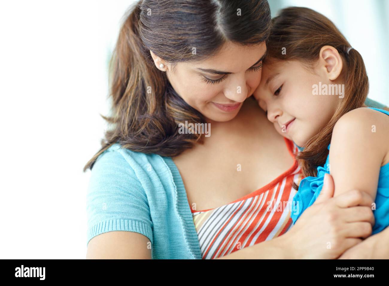 Nothing like a mothers love. A young mother hugging her cute daughter affectionately Stock Photo ...