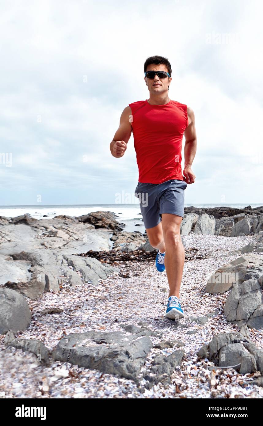 Nothing beats an early morning jog. A young athlete running outdoors ...