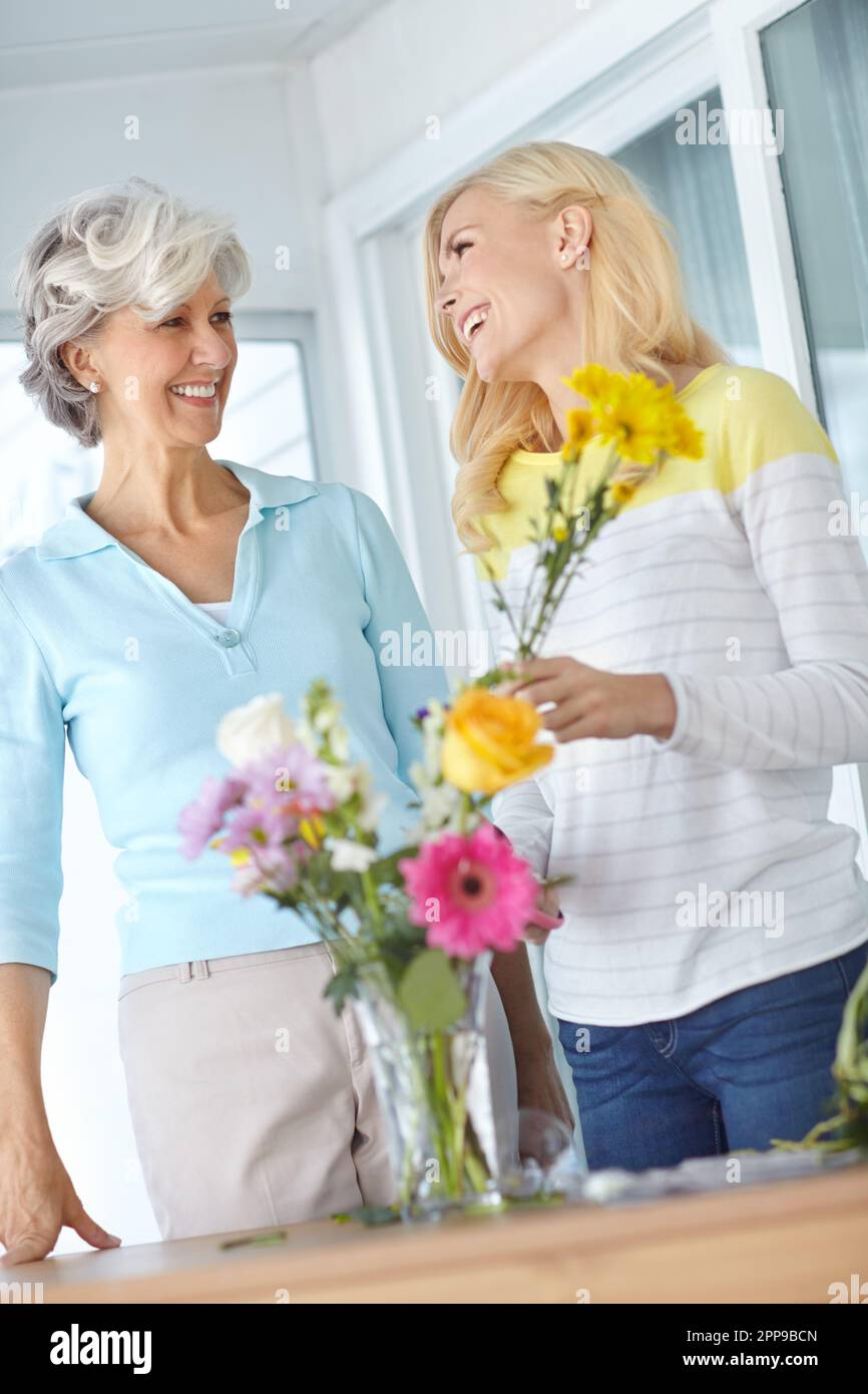 Sharing Their Passion For Flower Arrangements A Senior Woman Enjoying