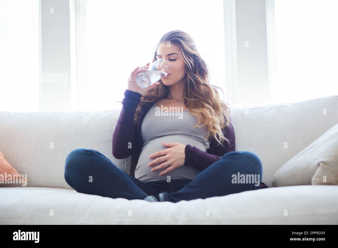 Staying hydrated for two. Full length shot of an attractive young ...