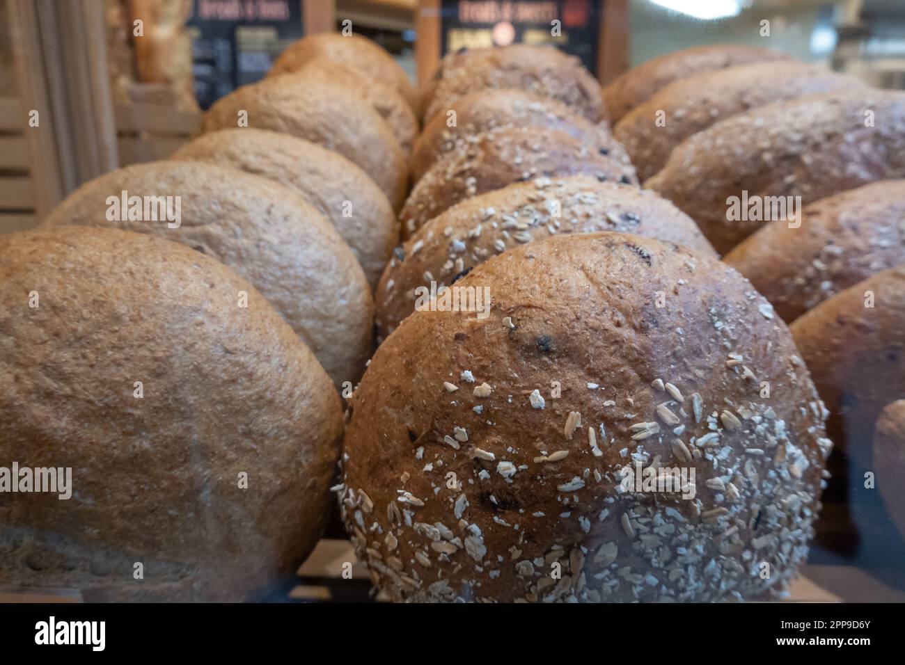 Loaves of bread on display in bakery Stock Photo - Alamy